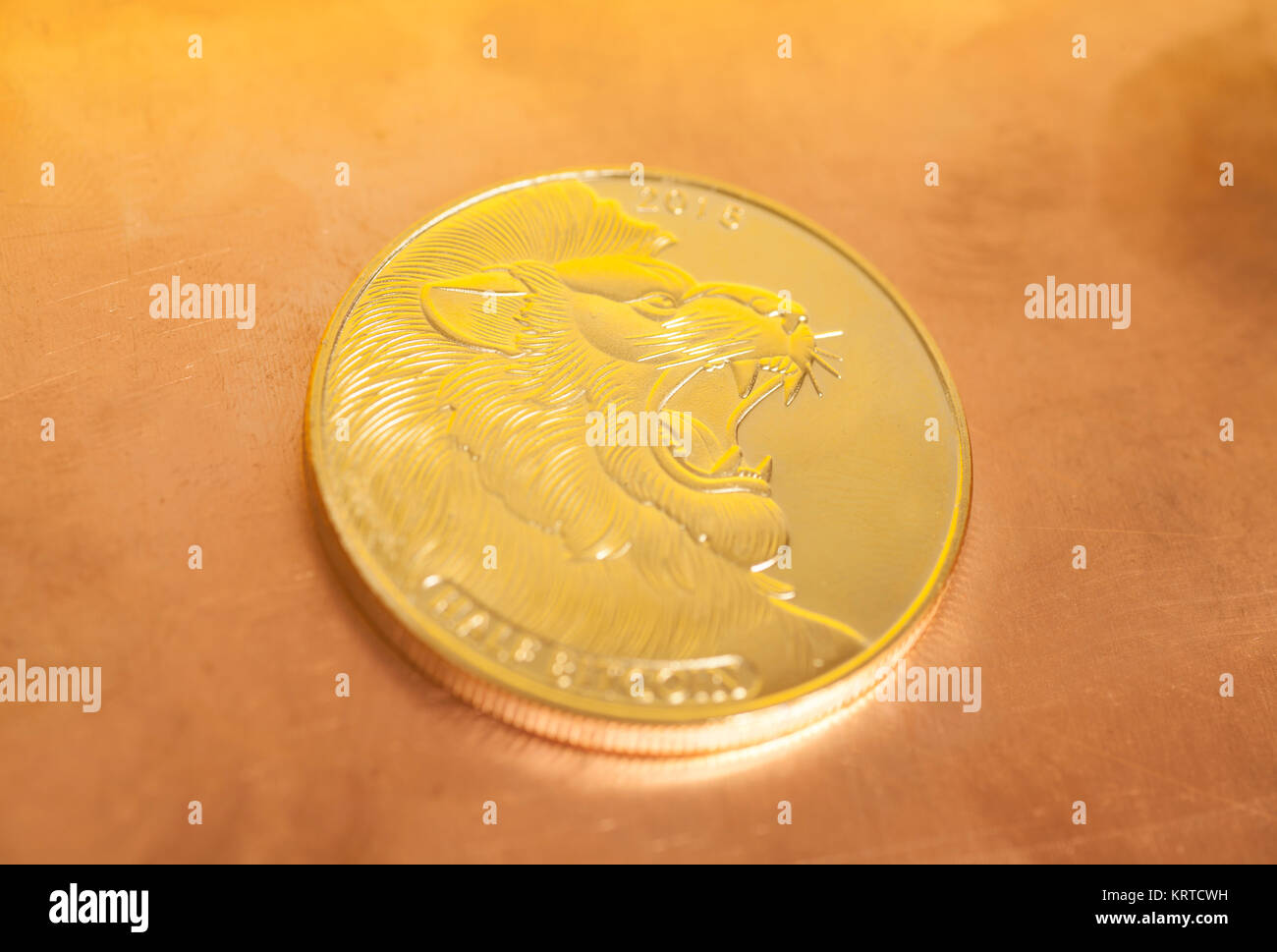 Half bitcoin with lion on a copper background Stock Photo - Alamy