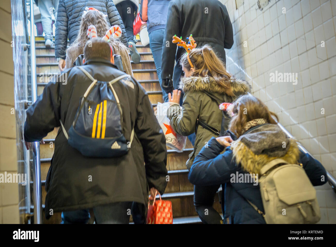 Christmas travelers crowd the stairs exiting a subway in New York on ...