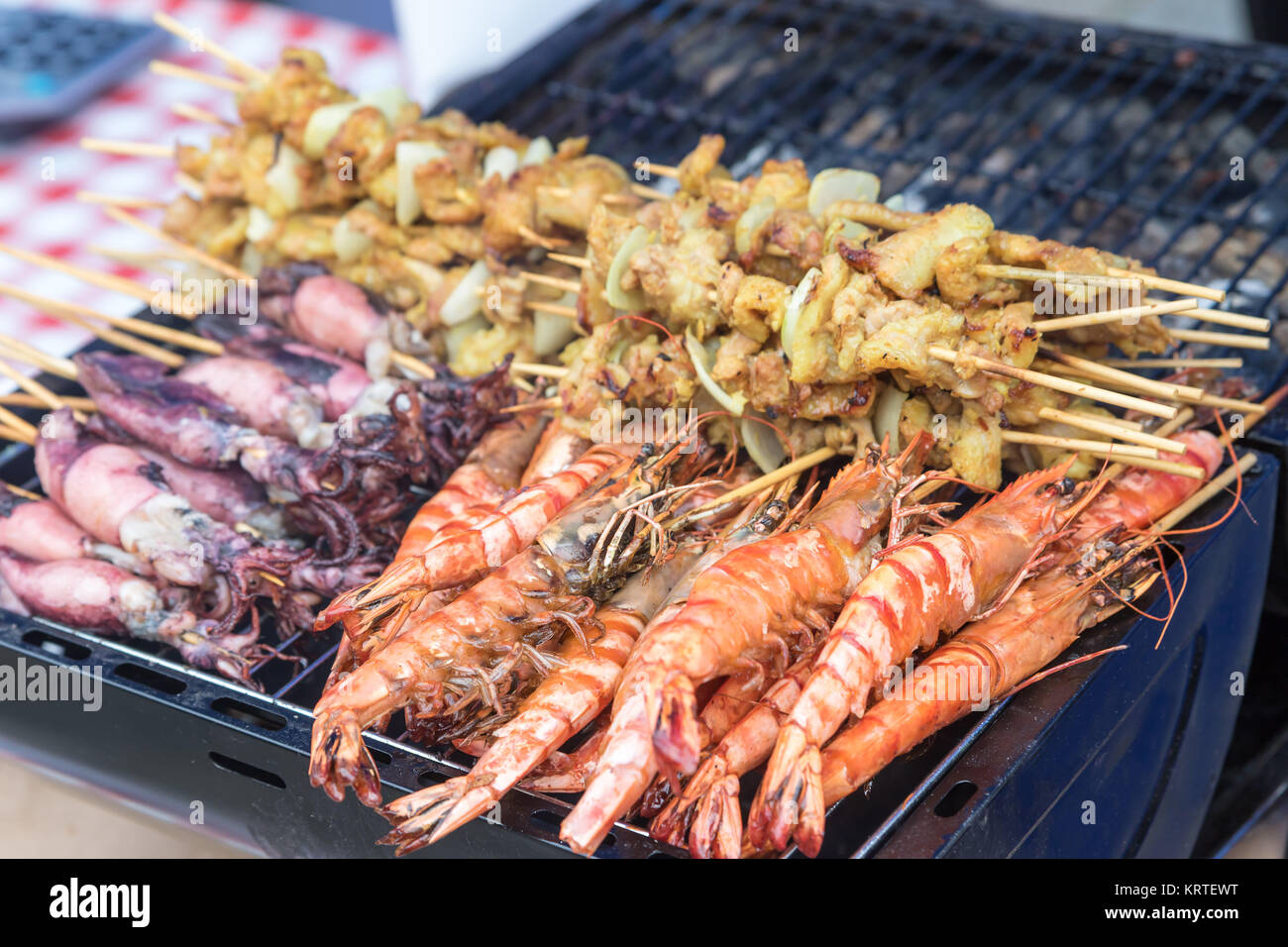 Street food - Side view of grilled seafood Stock Photo - Alamy