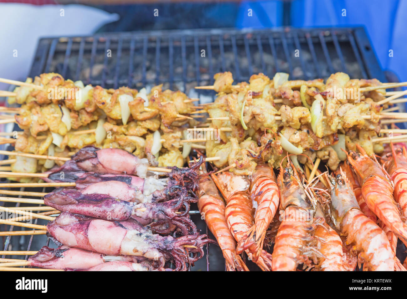 Street food - Front view of grilled seafood Stock Photo - Alamy