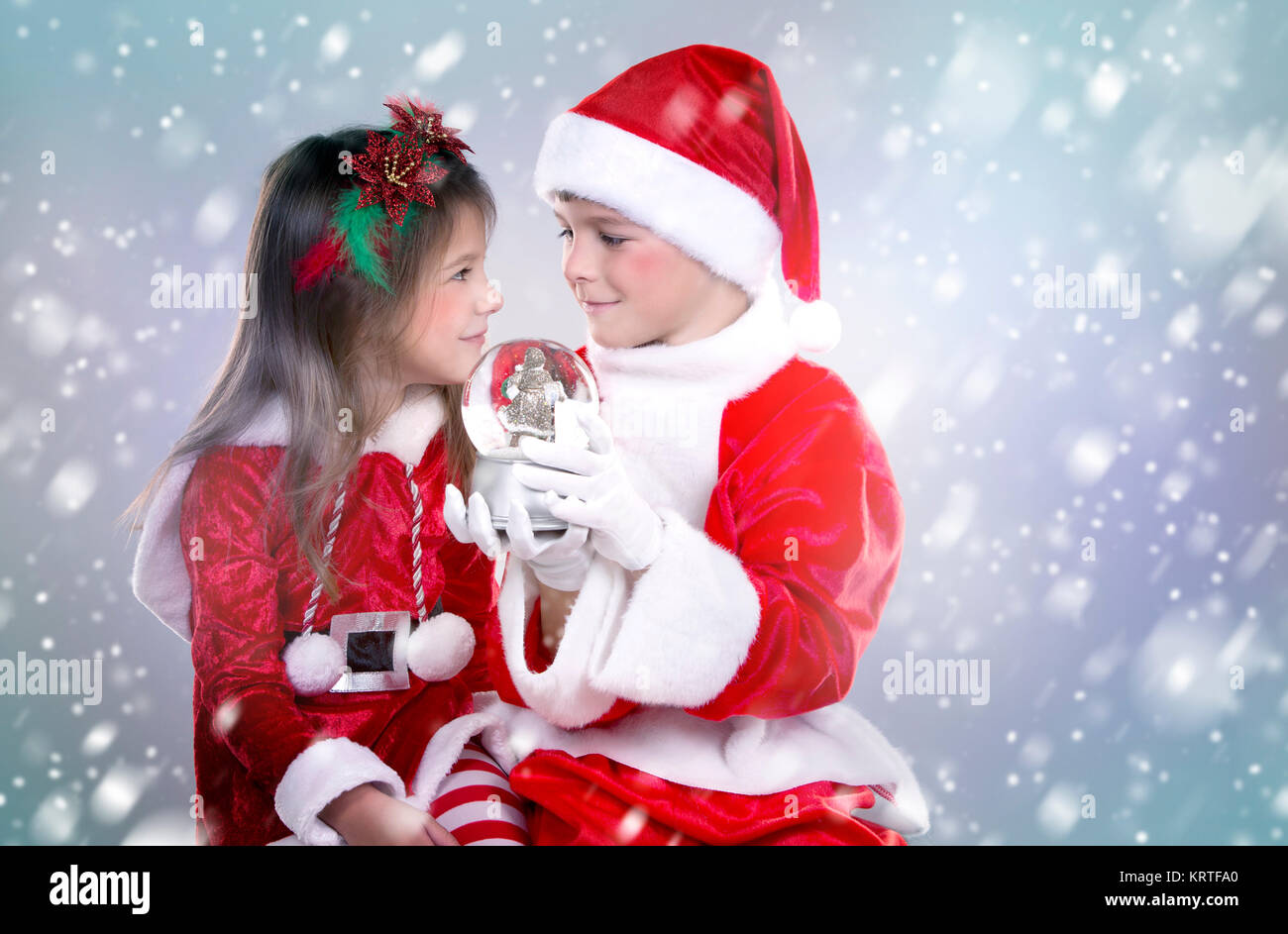 boy and girl as santa and elf Stock Photo - Alamy