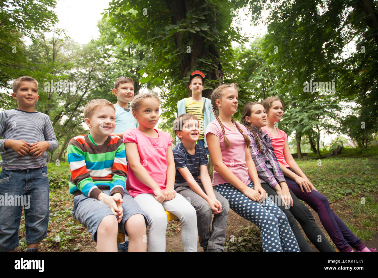 Group of children on a park bench Stock Photo - Alamy
