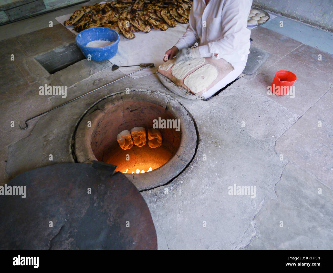Armenian bread baked in a tonir, Yerevan, Armenia. A woman bakes ...