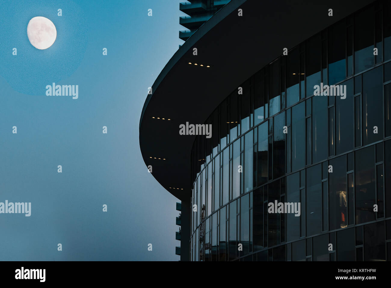 Modern building - evening view with moon Stock Photo - Alamy
