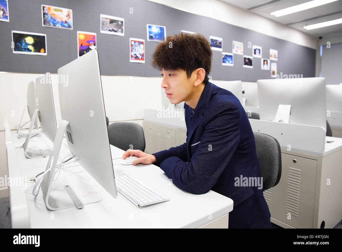 young man using computer in classroom Stock Photo - Alamy