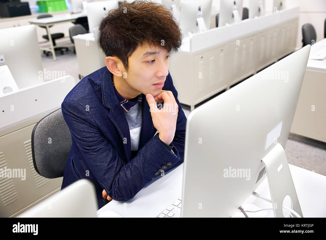 young man using computer in classroom Stock Photo - Alamy