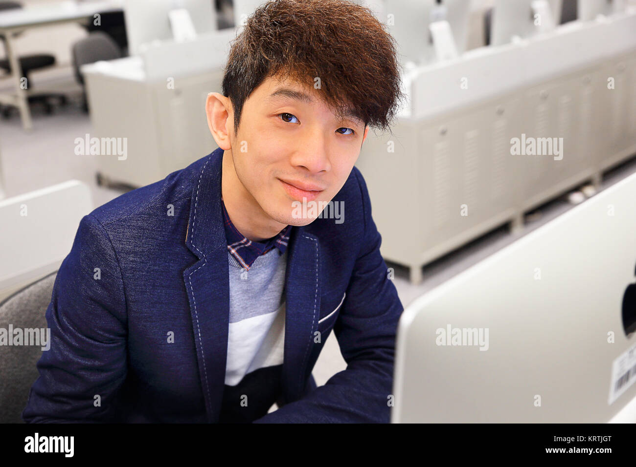 young man using computer in classroom Stock Photo - Alamy