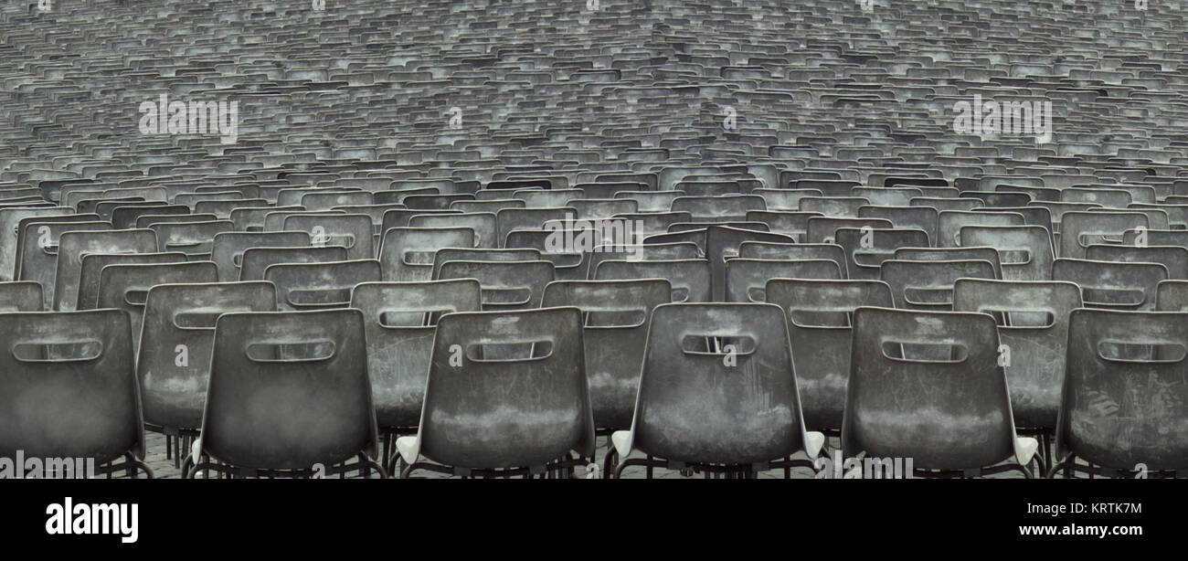 Beautiful abstract of many backs of black chairs positioned for an ...