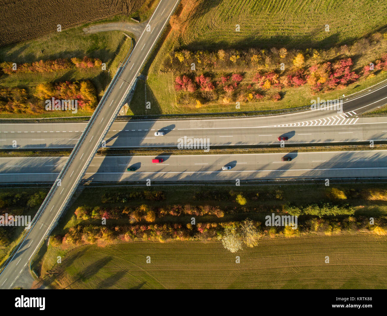 Aerial view of a highway amid fields with cars on it Stock Photo - Alamy