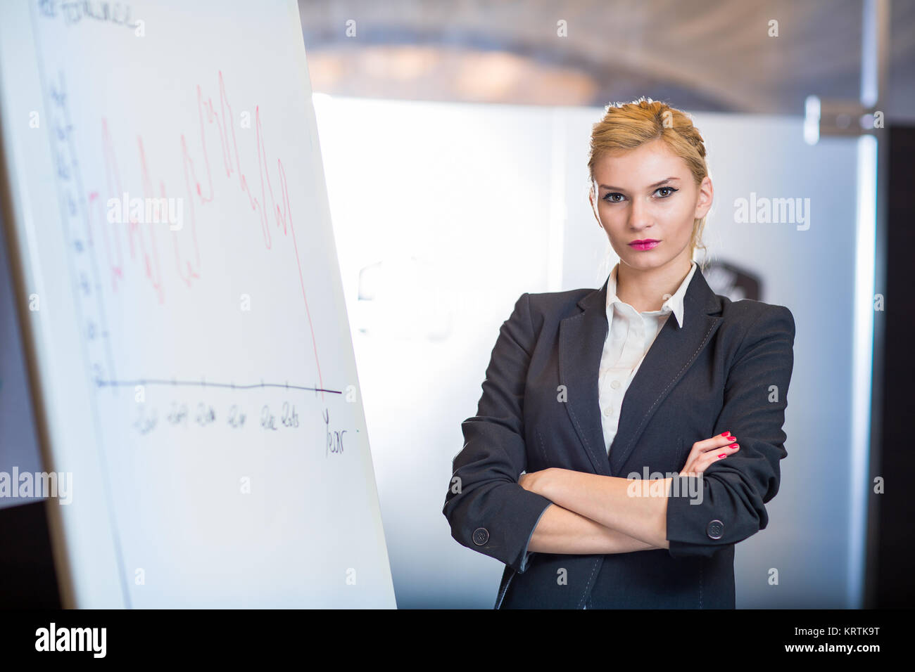 Pretty, young business woman giving a presentation in a conference ...