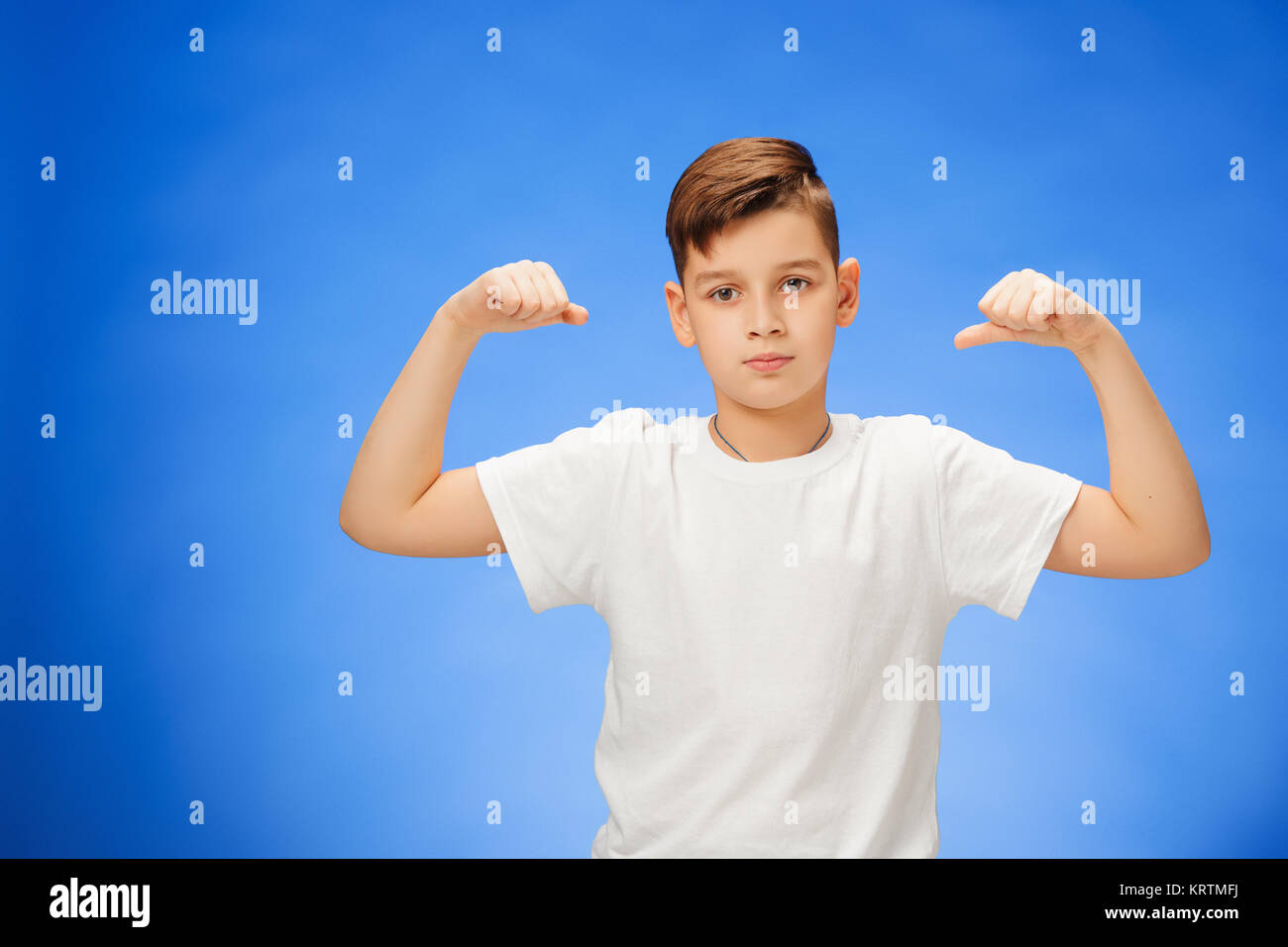 Beauty smiling sport child boy showing his biceps Stock Photo - Alamy