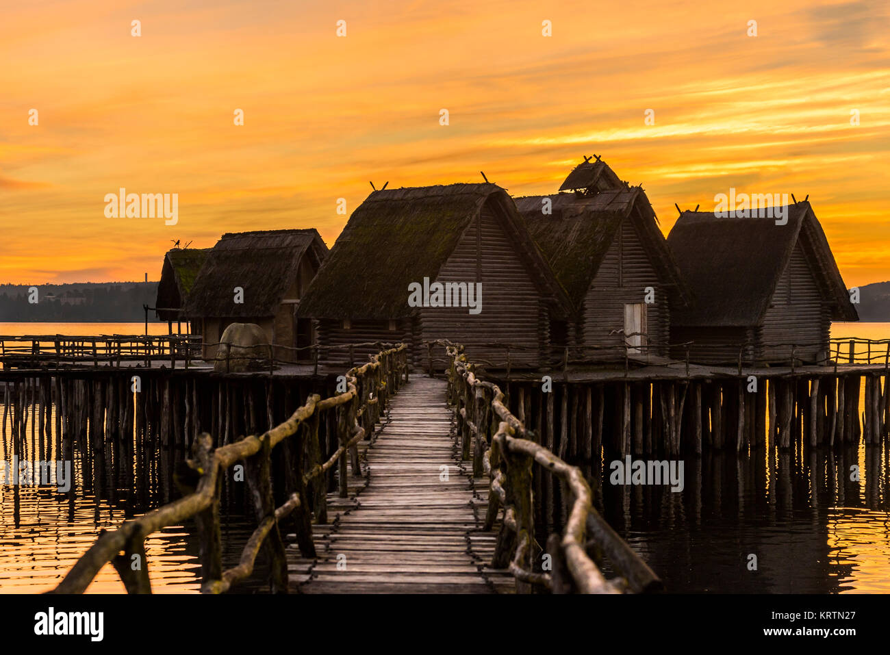 Wooden bridge and houses suspended over lake water Stock Photo - Alamy