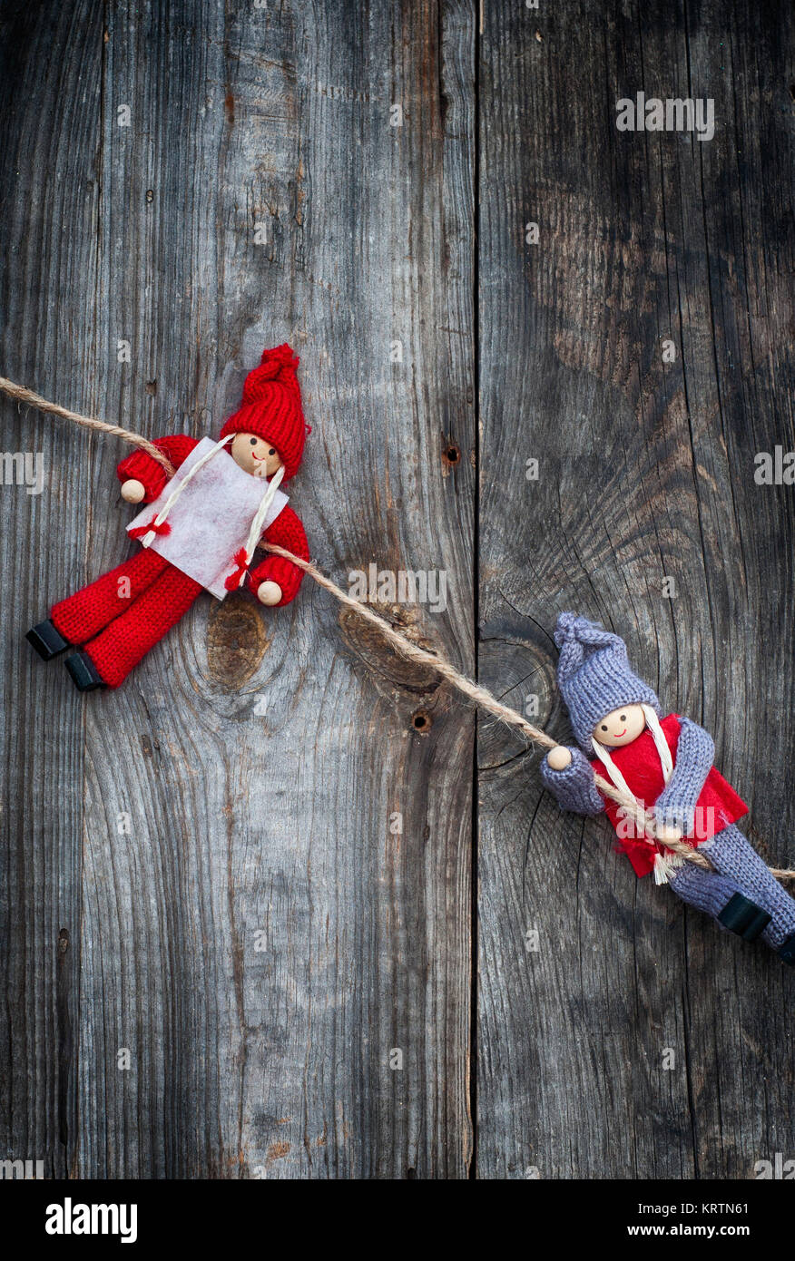 two little rag dolls hanging from a rope Stock Photo - Alamy
