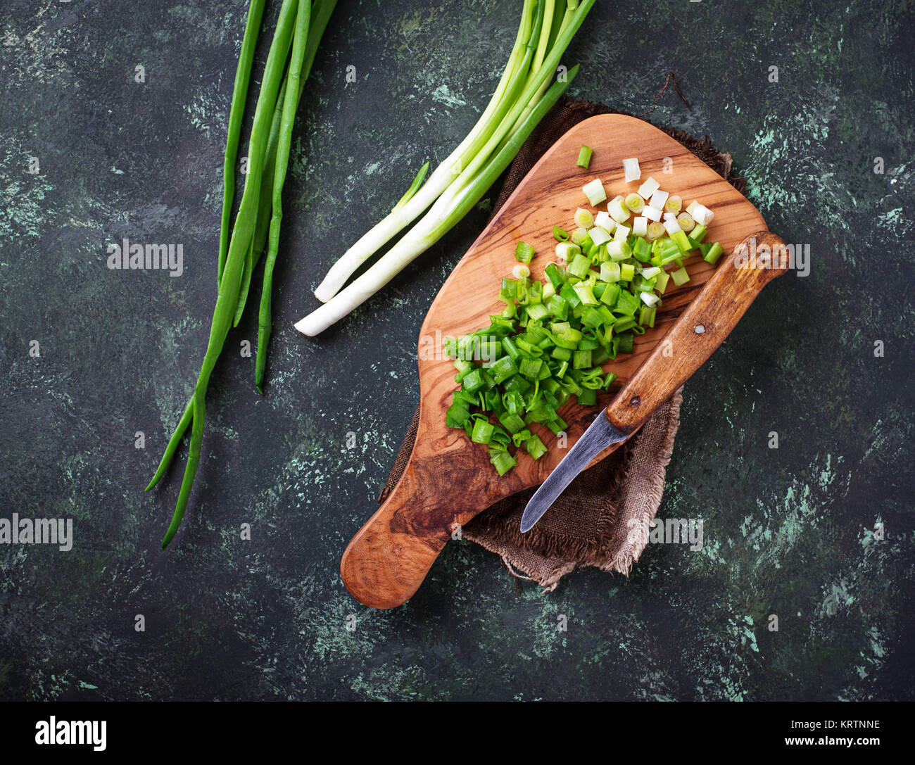Chopped green onions on concrete background. Selective focus, top view ...