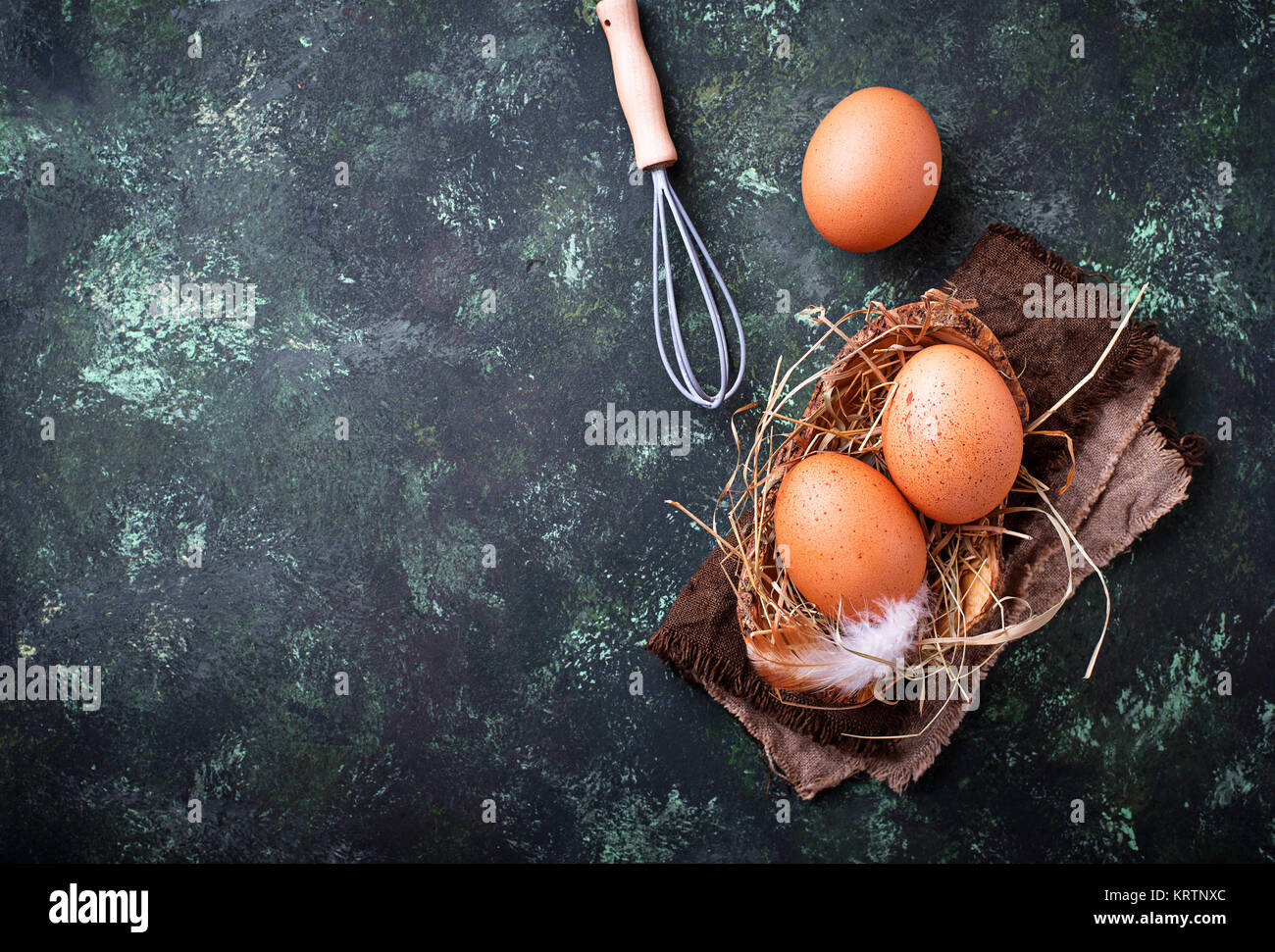 Raw chicken eggs and whisk. Top view Stock Photo - Alamy