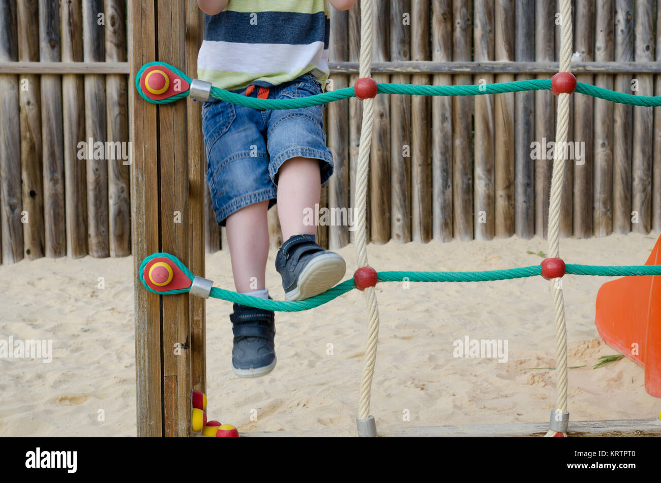 Little boy climbing on a climbing frame Stock Photo - Alamy