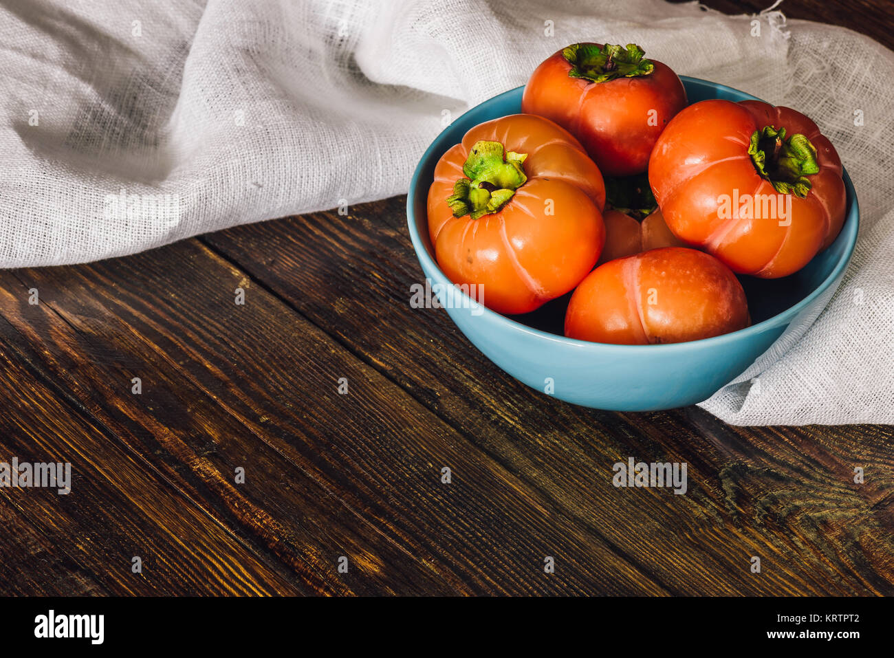Persimmons in Blue Bowl Stock Photo - Alamy