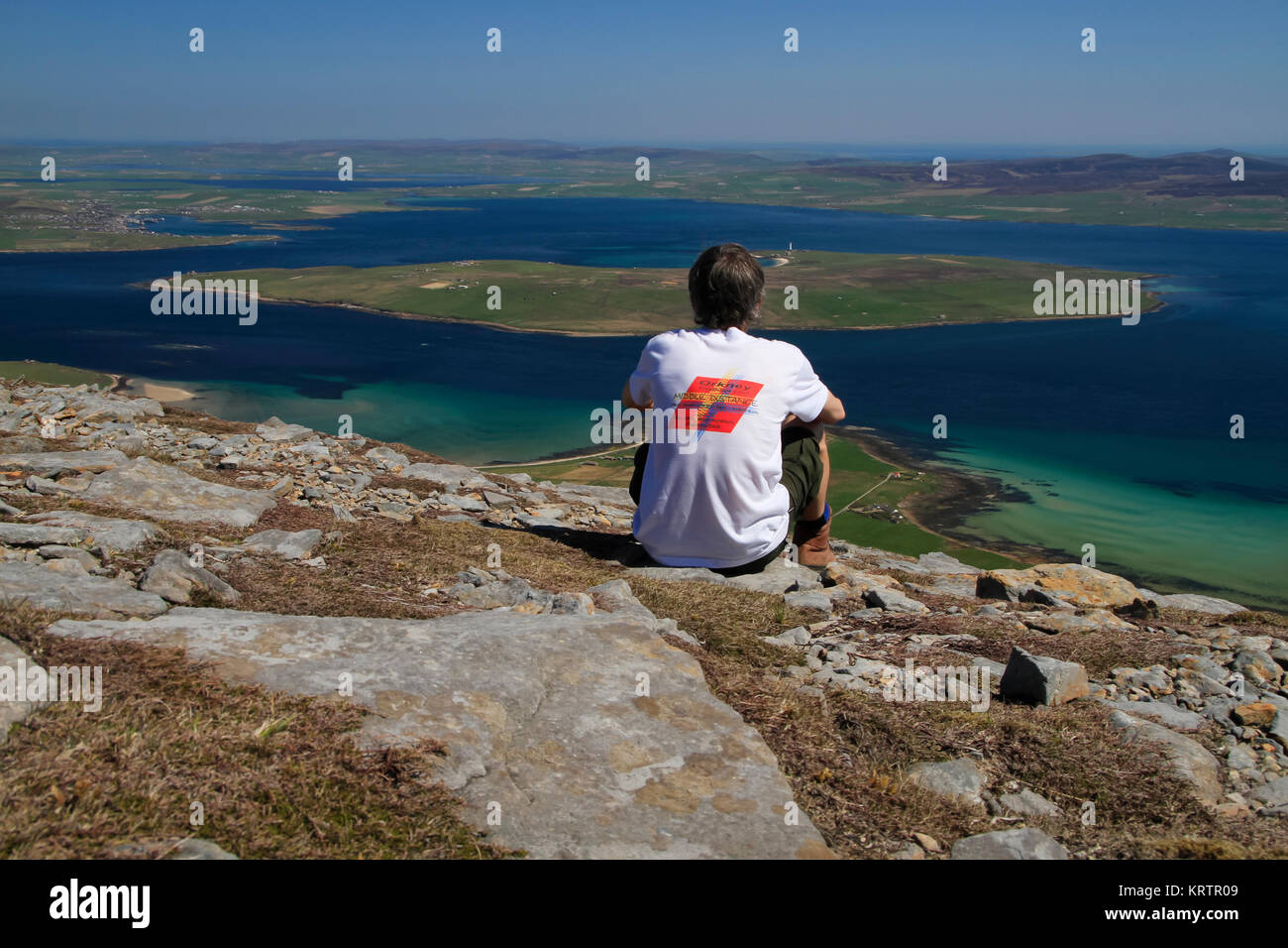 Male sitting on the summit of Ward Hill, Orkney's highest hill Stock ...