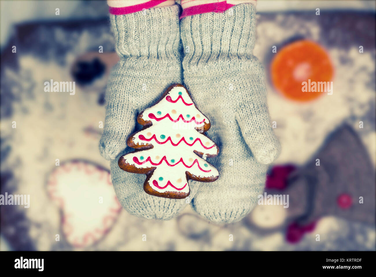 Child hands in gloves holding gingerbread cookie Stock Photo - Alamy