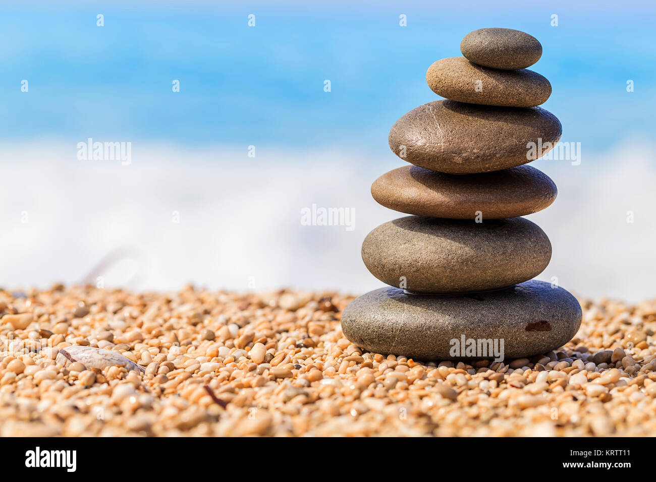 Stones balance, pebbles stack over blue sea Stock Photo - Alamy