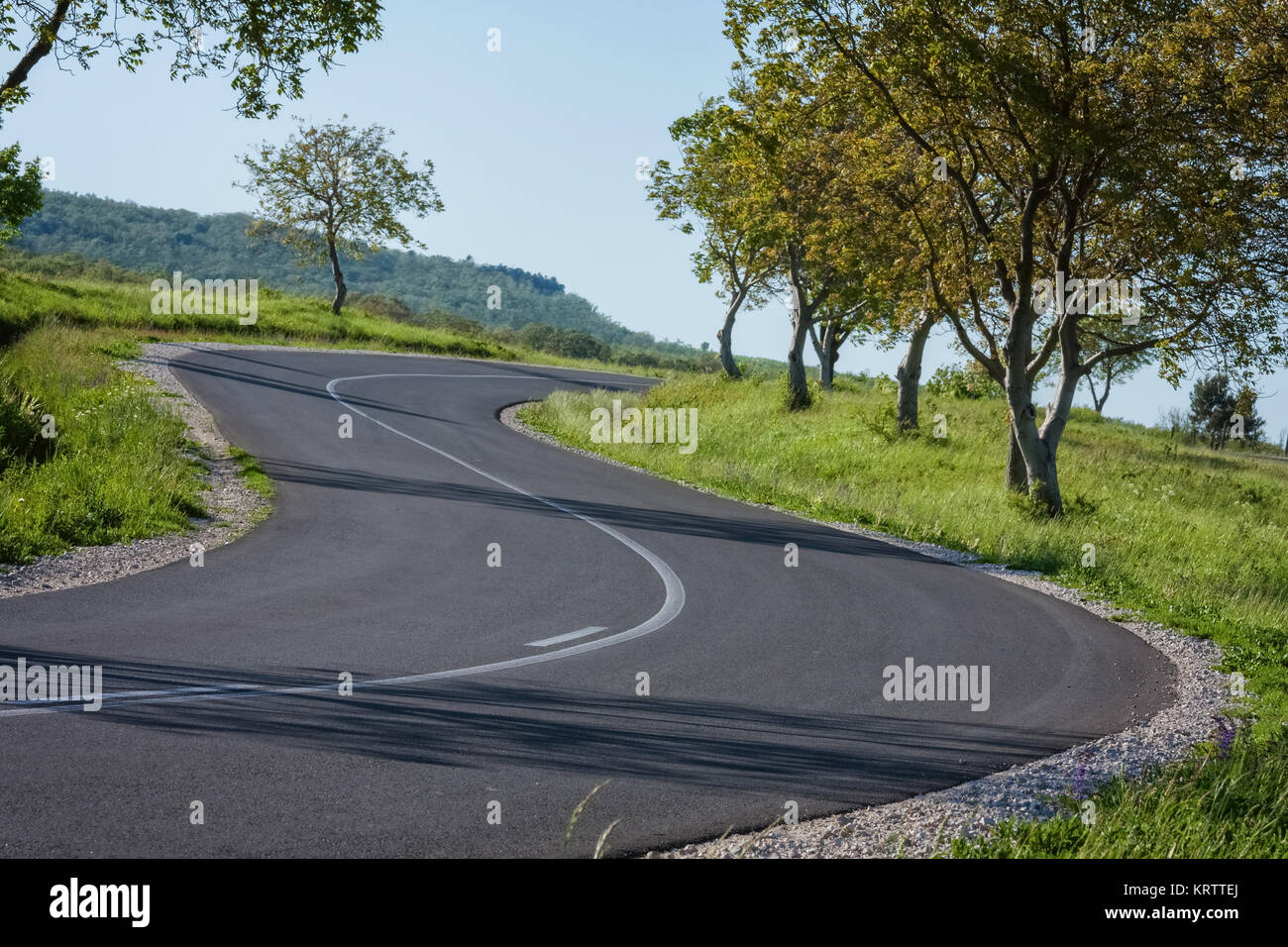 Straight asphalt road leading into the distance Stock Photo - Alamy