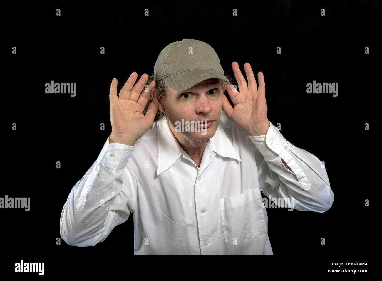 Man listens with his Hands on his Ears Stock Photo - Alamy