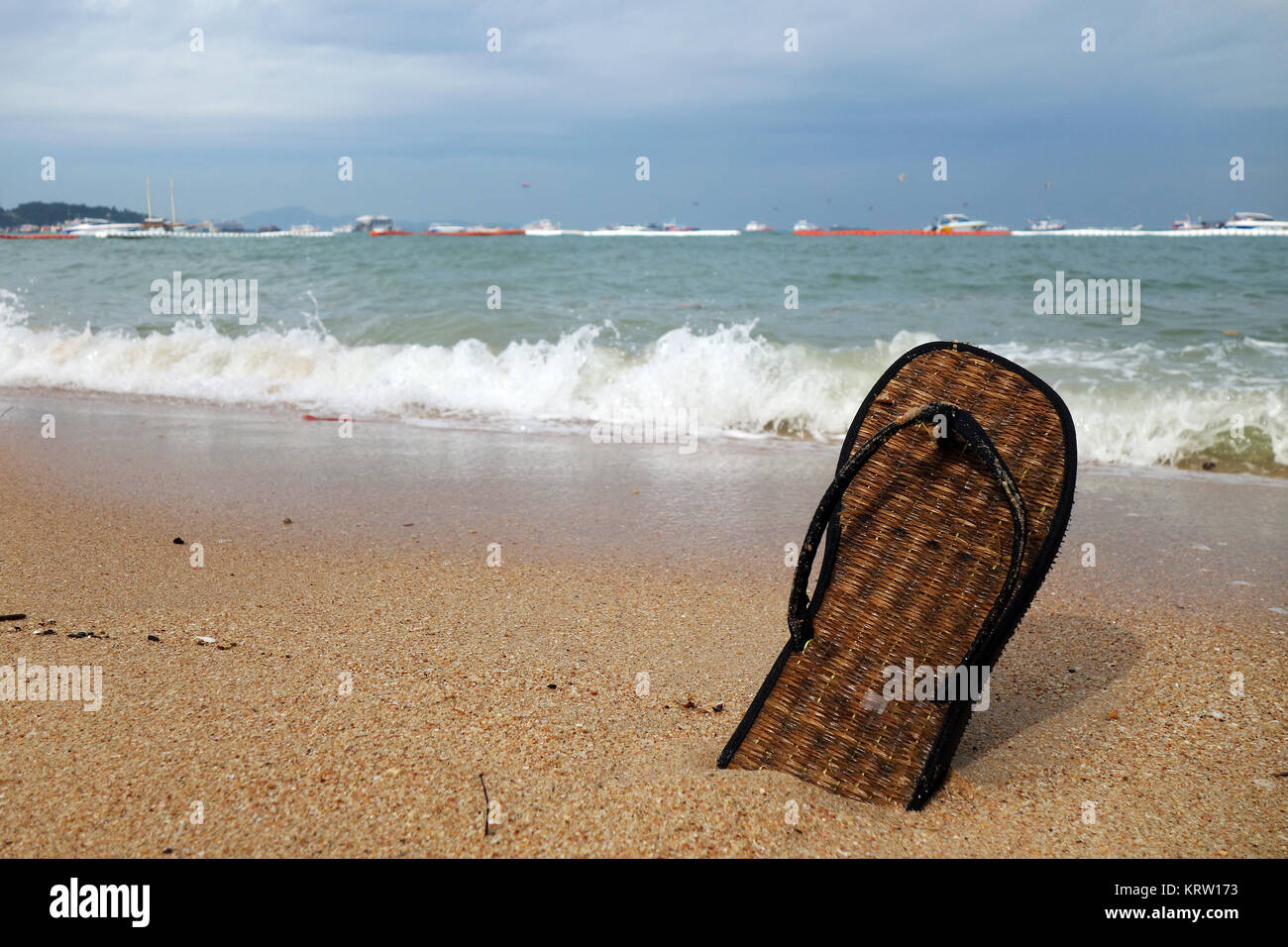 Beach slippers on a sandy beach Stock Photo - Alamy