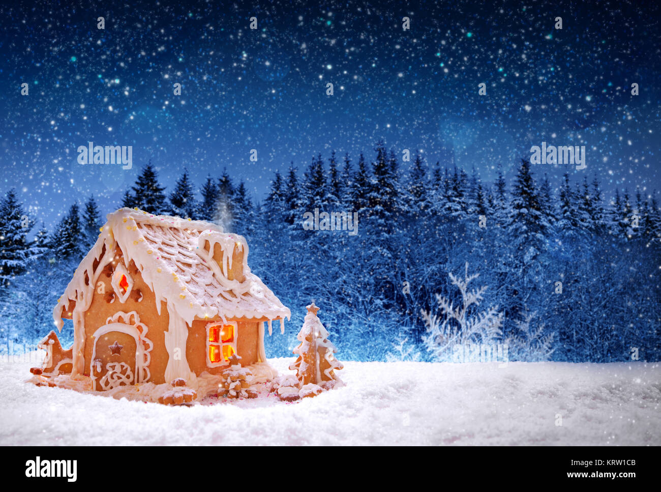 Gingerbread house isolated on fir trees forest background. Christmas ...