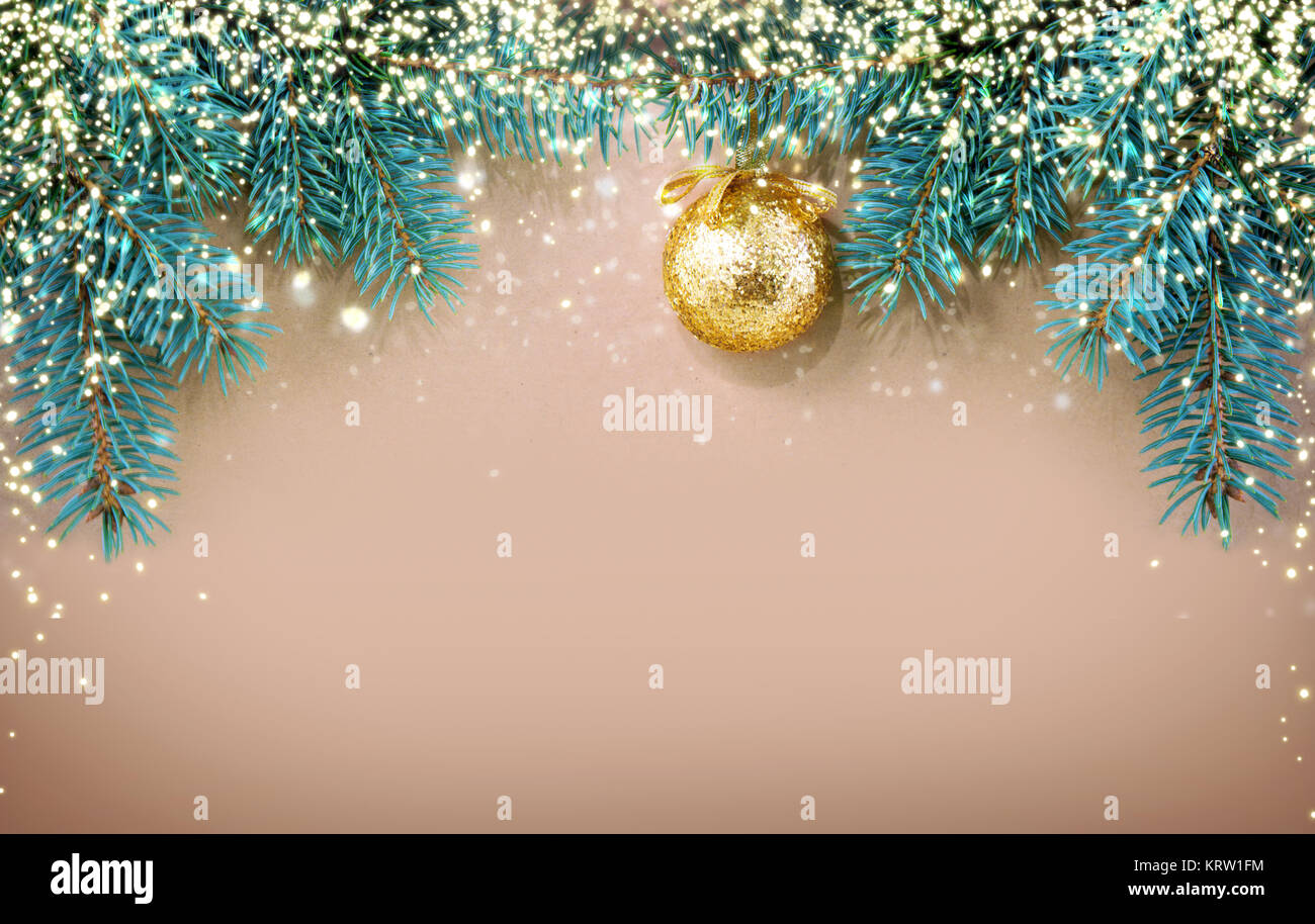 Golden Christmas ball on spruce branch isolated on brown background ...