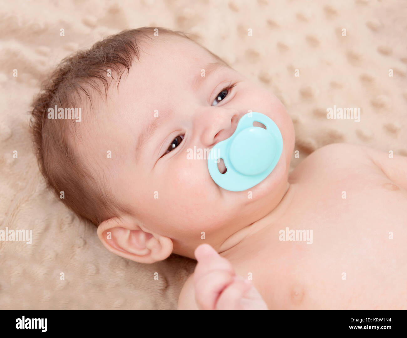 Cute baby smiling with blue pacifier Stock Photo - Alamy