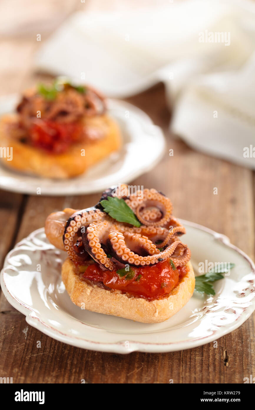 Bruschetta with baby octopuses Stock Photo - Alamy
