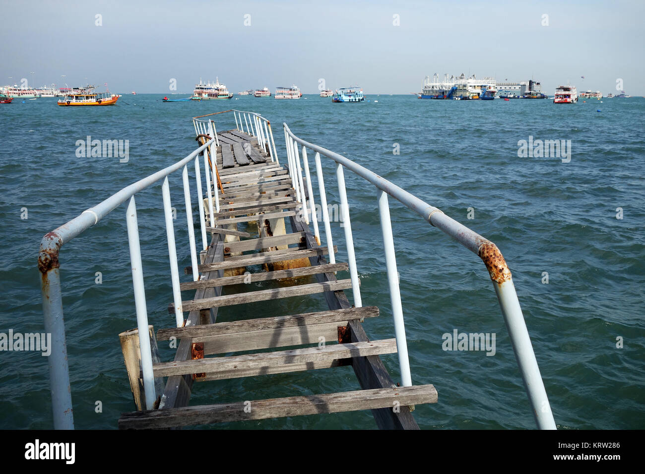 The wooden bridge extending into the sea Stock Photo - Alamy