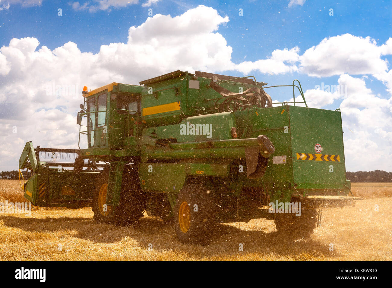 combine harvester working on a wheat field Stock Photo - Alamy