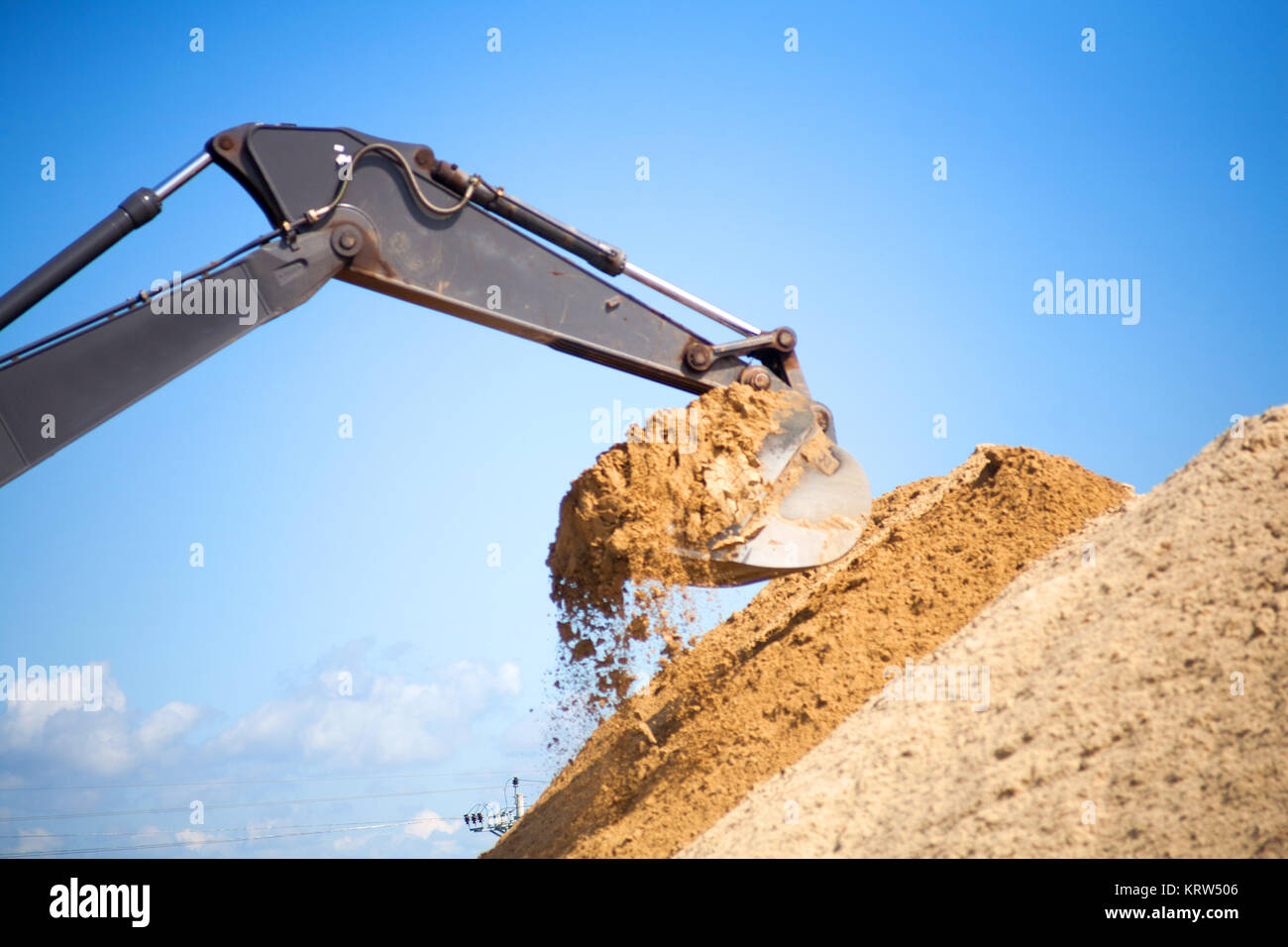 A large construction excavator of yellow color on the construction site ...