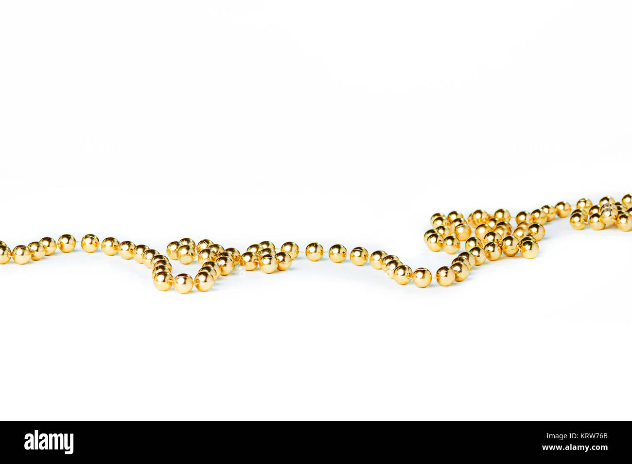 Gold Christmas bump beads on white Stock Photo - Alamy