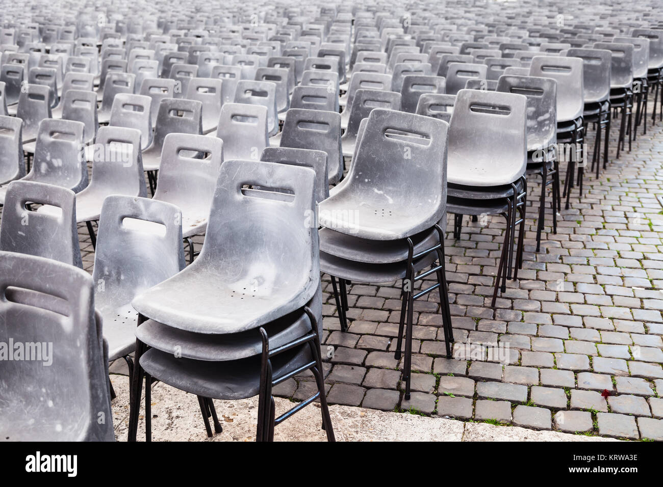 many old empty plastic chairs on urban square Stock Photo - Alamy