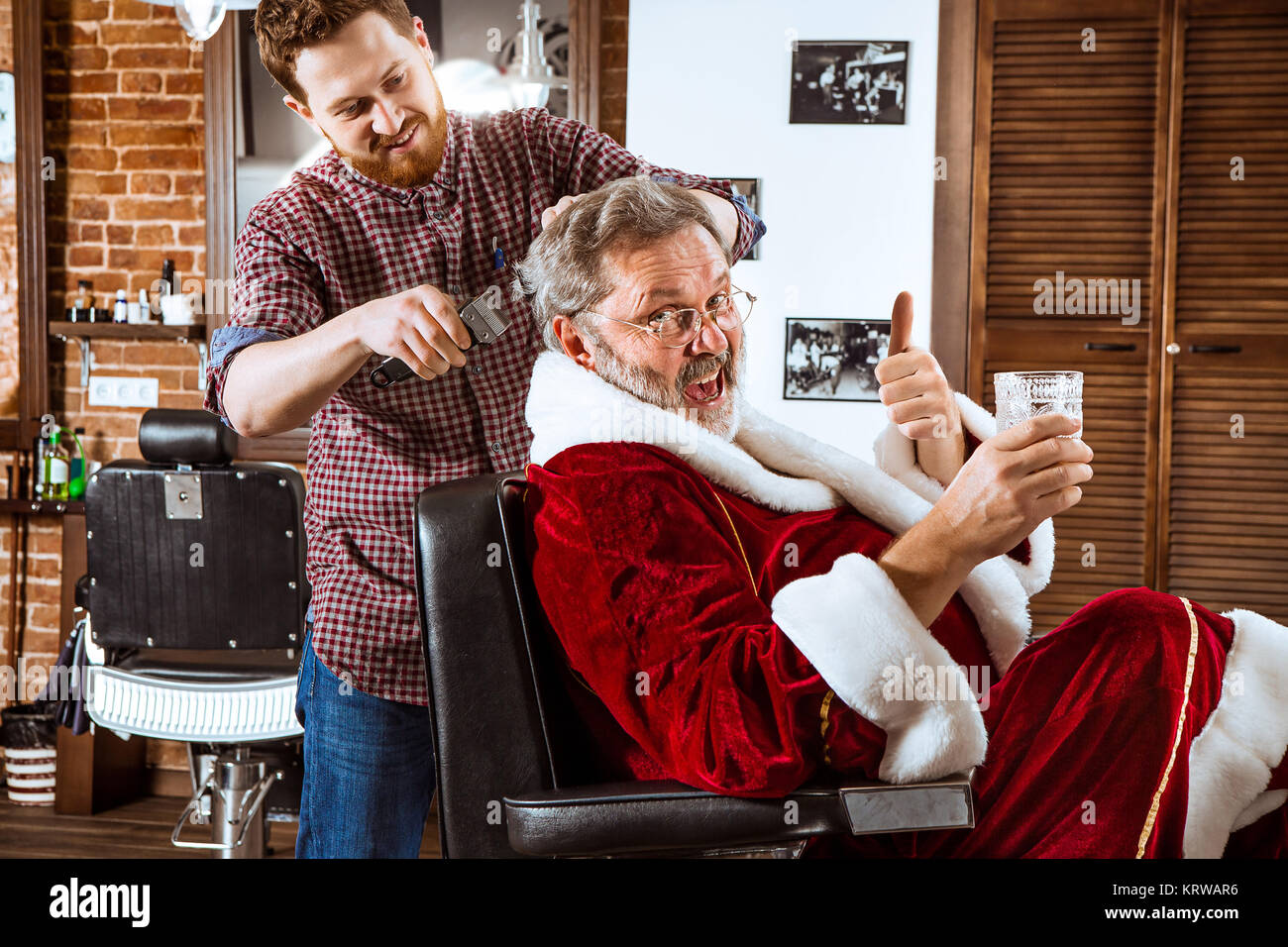 Santa claus shaving his personal barber Stock Photo - Alamy