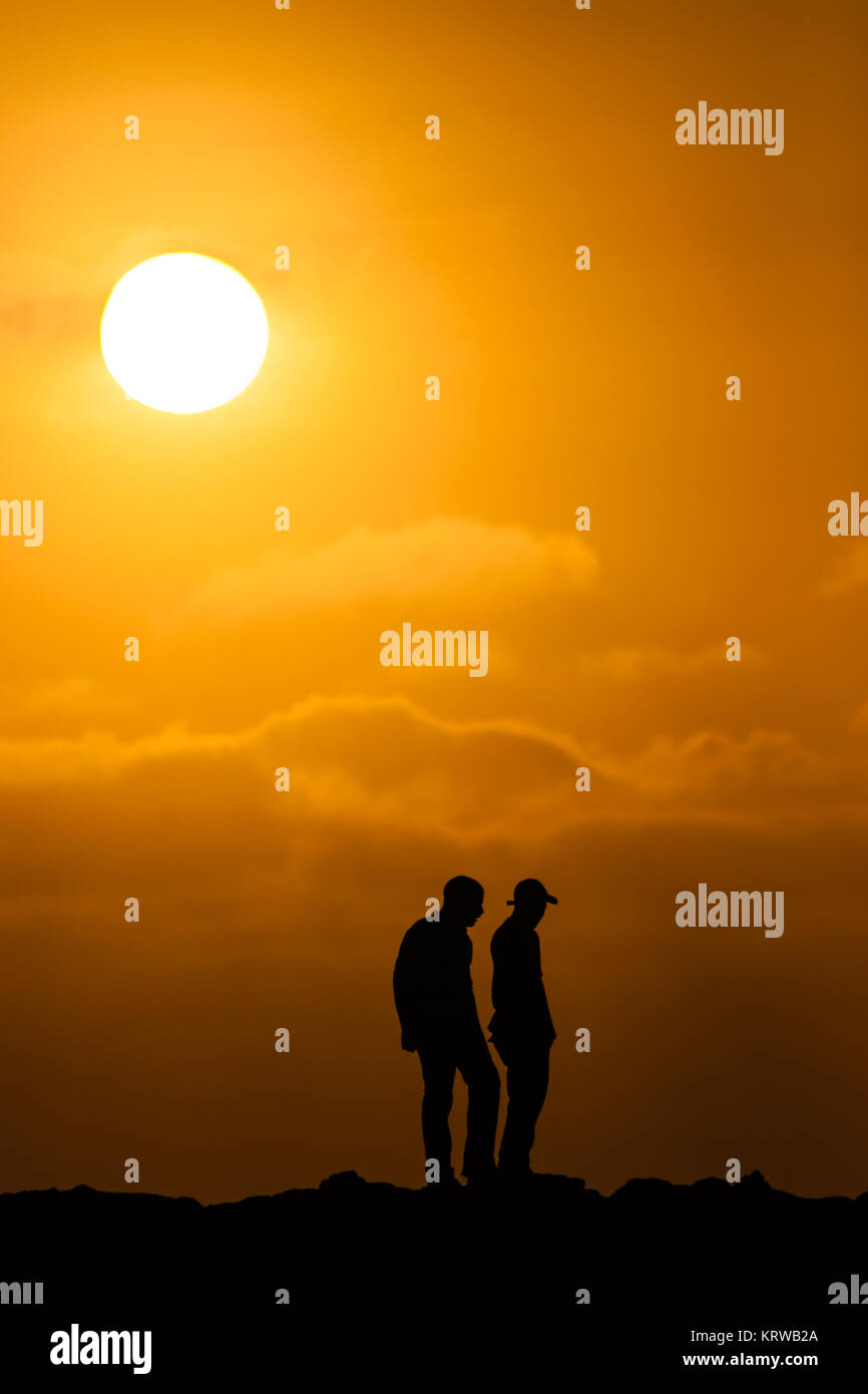 Friends at sunset Stock Photo - Alamy