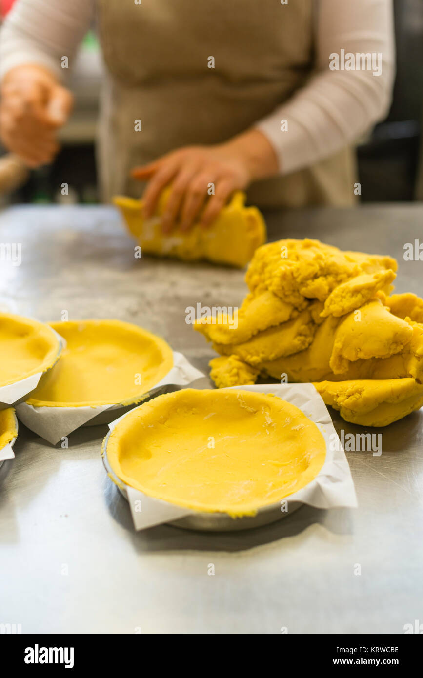 Chef pastry baker woman preparing and working out the dought made with ...
