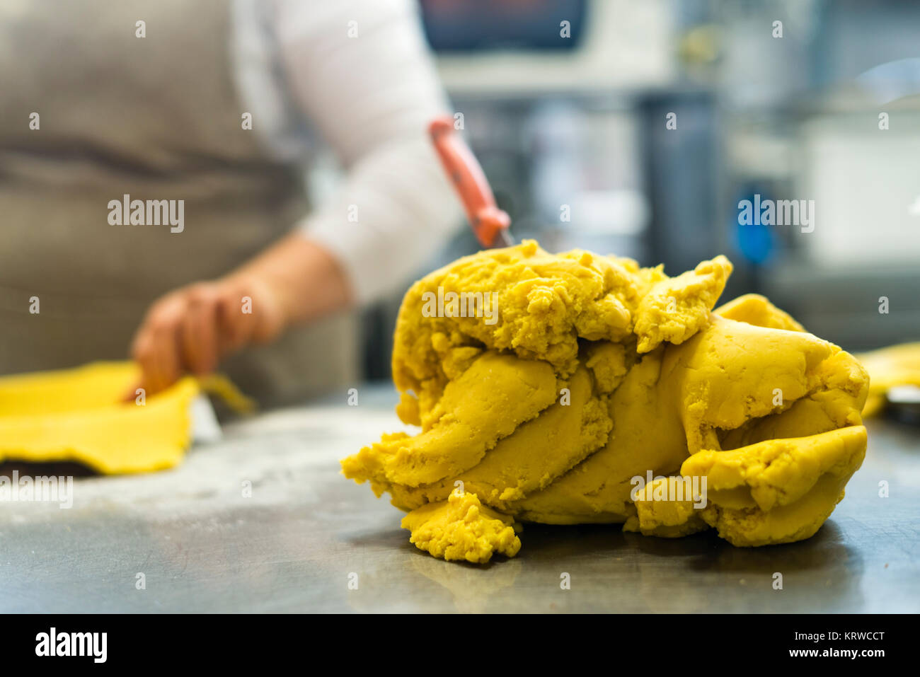 Chef pastry baker woman preparing and working out the dought made with ...