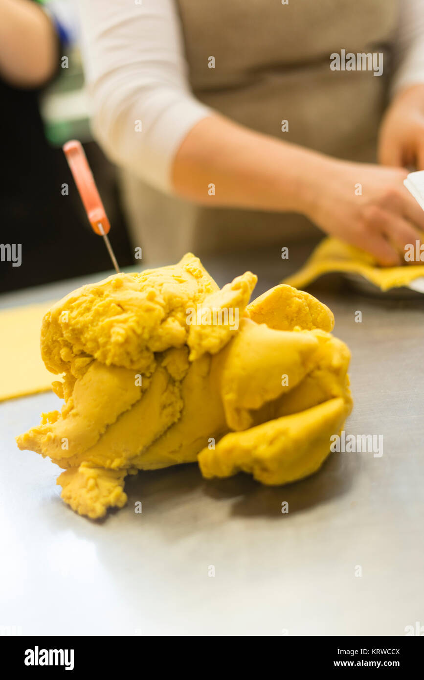 Chef pastry baker woman preparing and working out the dought made with ...