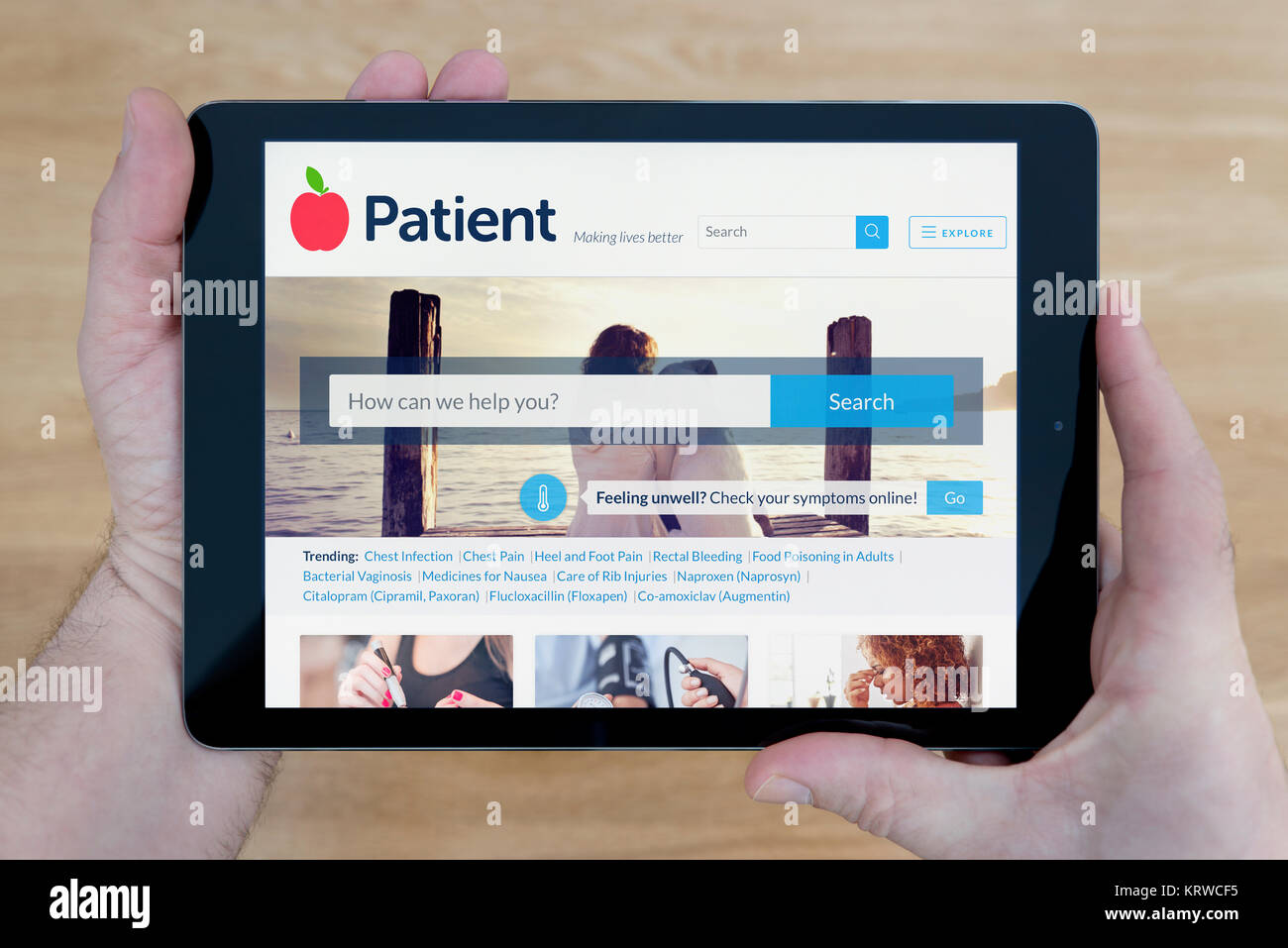 A man looks at the Patient website on his iPad tablet device, shot ...