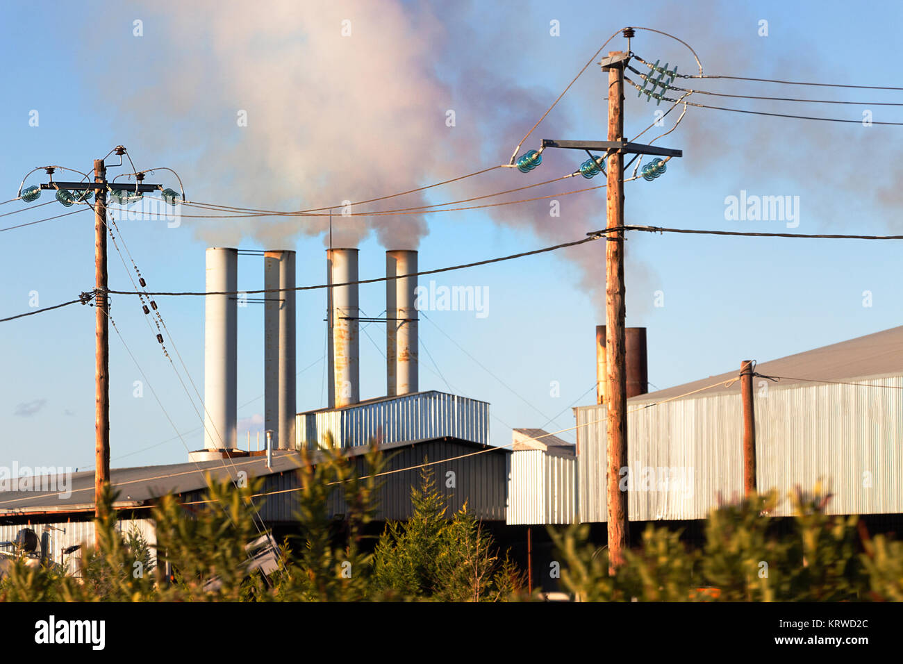 Four giant chimneys pointing into the sky from a industrial factory in ...