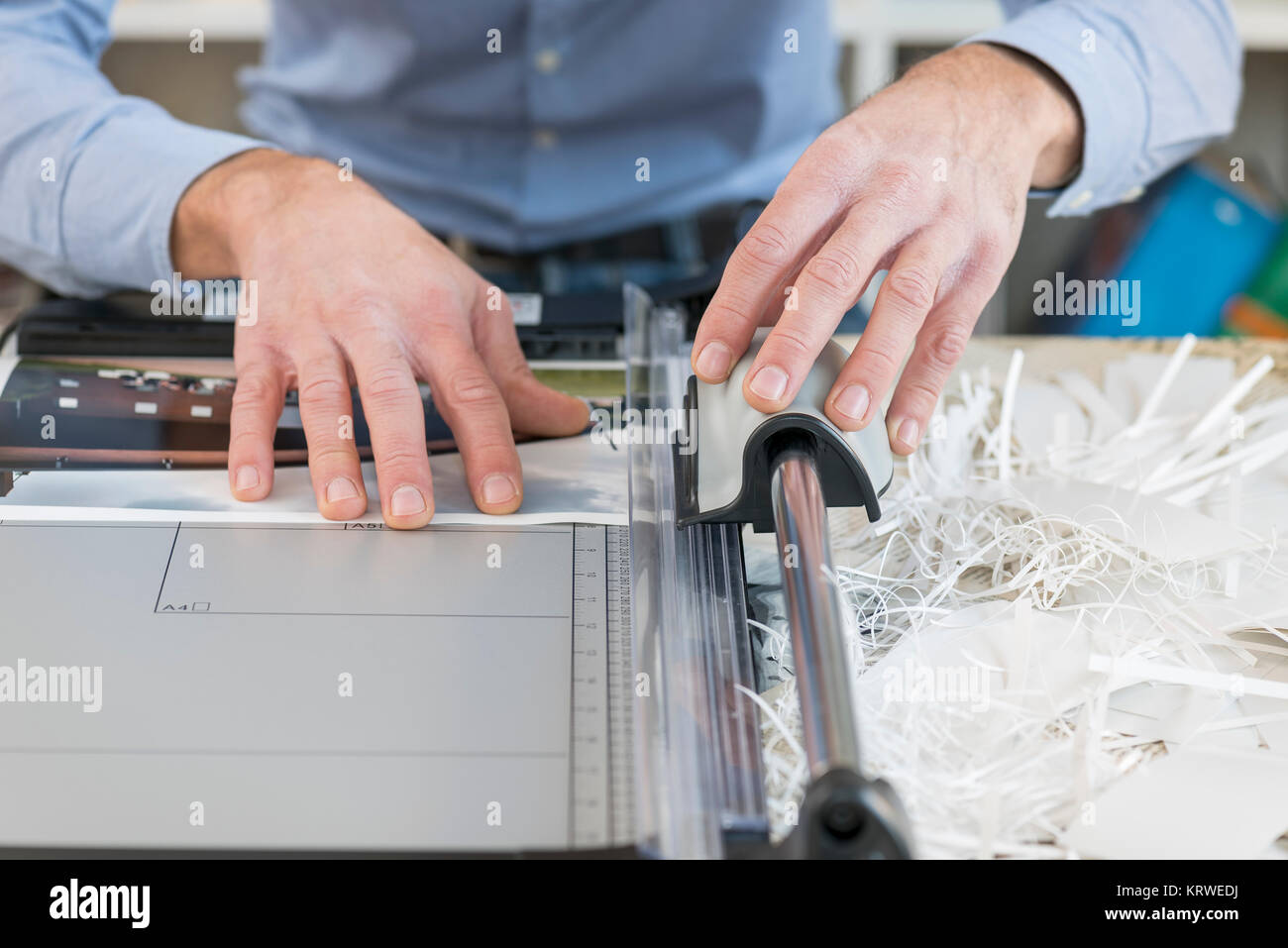 man cutting print with precision cutter Stock Photo - Alamy