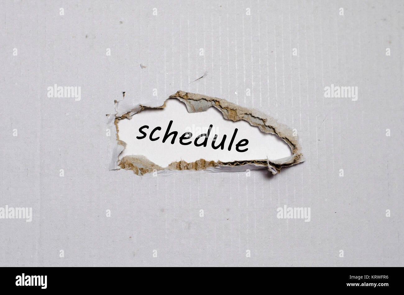 The word schedule appearing behind torn paper Stock Photo - Alamy