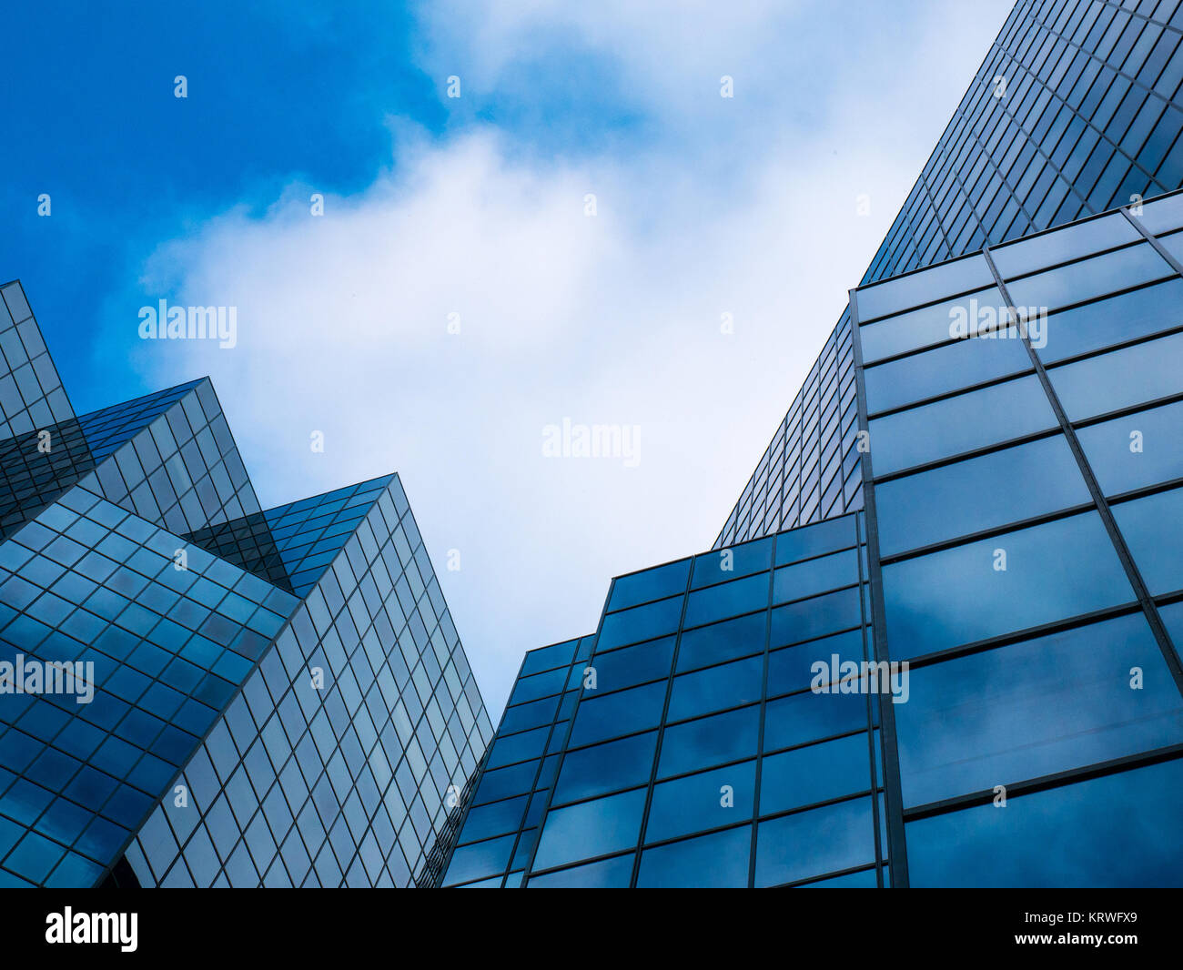 Modern skyscraper with reflection of the sky on the windows. Blue sky ...