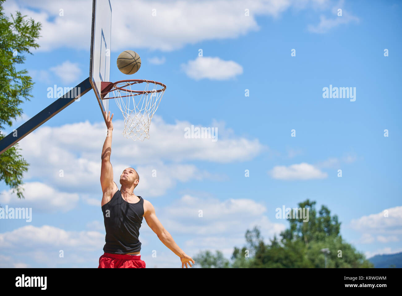 Basketball player in action flying high and scoring Stock Photo - Alamy