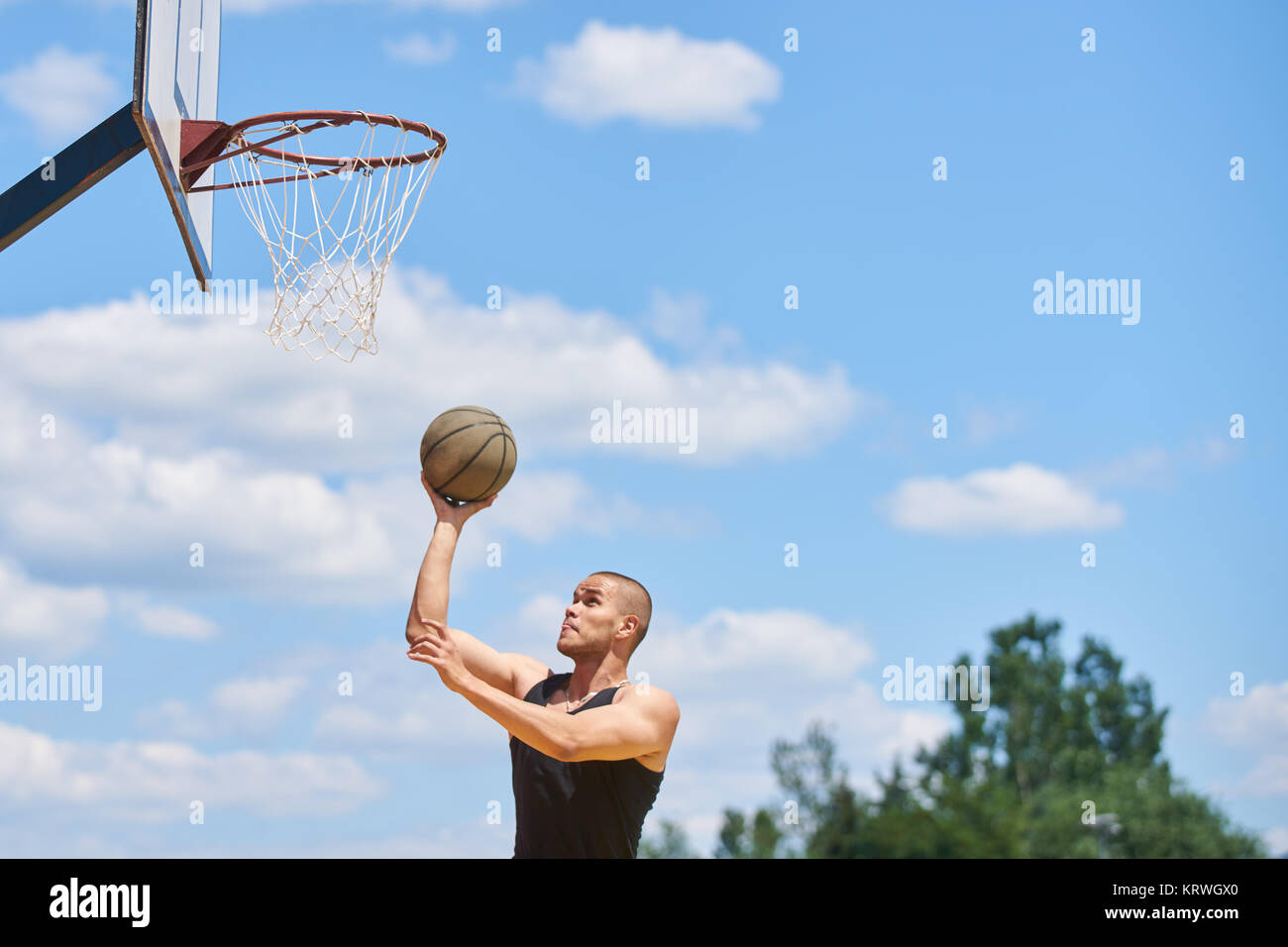 Basketball player in action flying high and scoring Stock Photo - Alamy