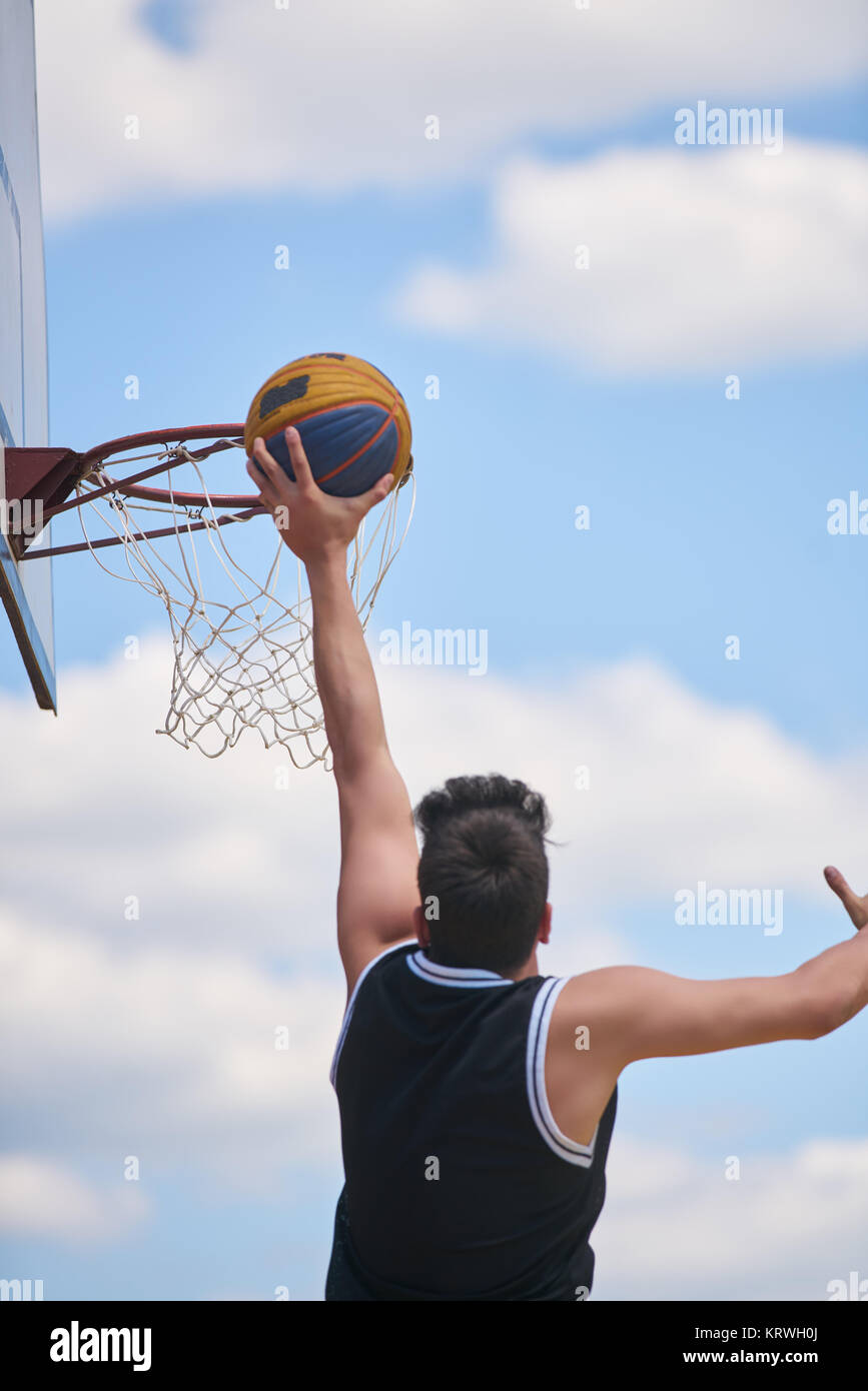 Basketball player in action flying high and scoring Stock Photo - Alamy