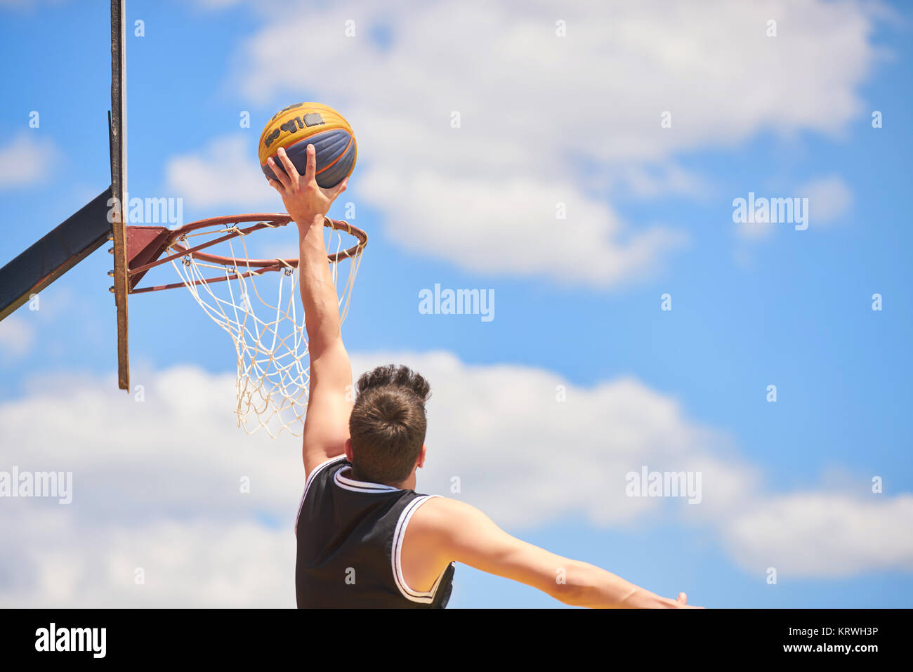 Basketball player in action flying high and scoring Stock Photo - Alamy